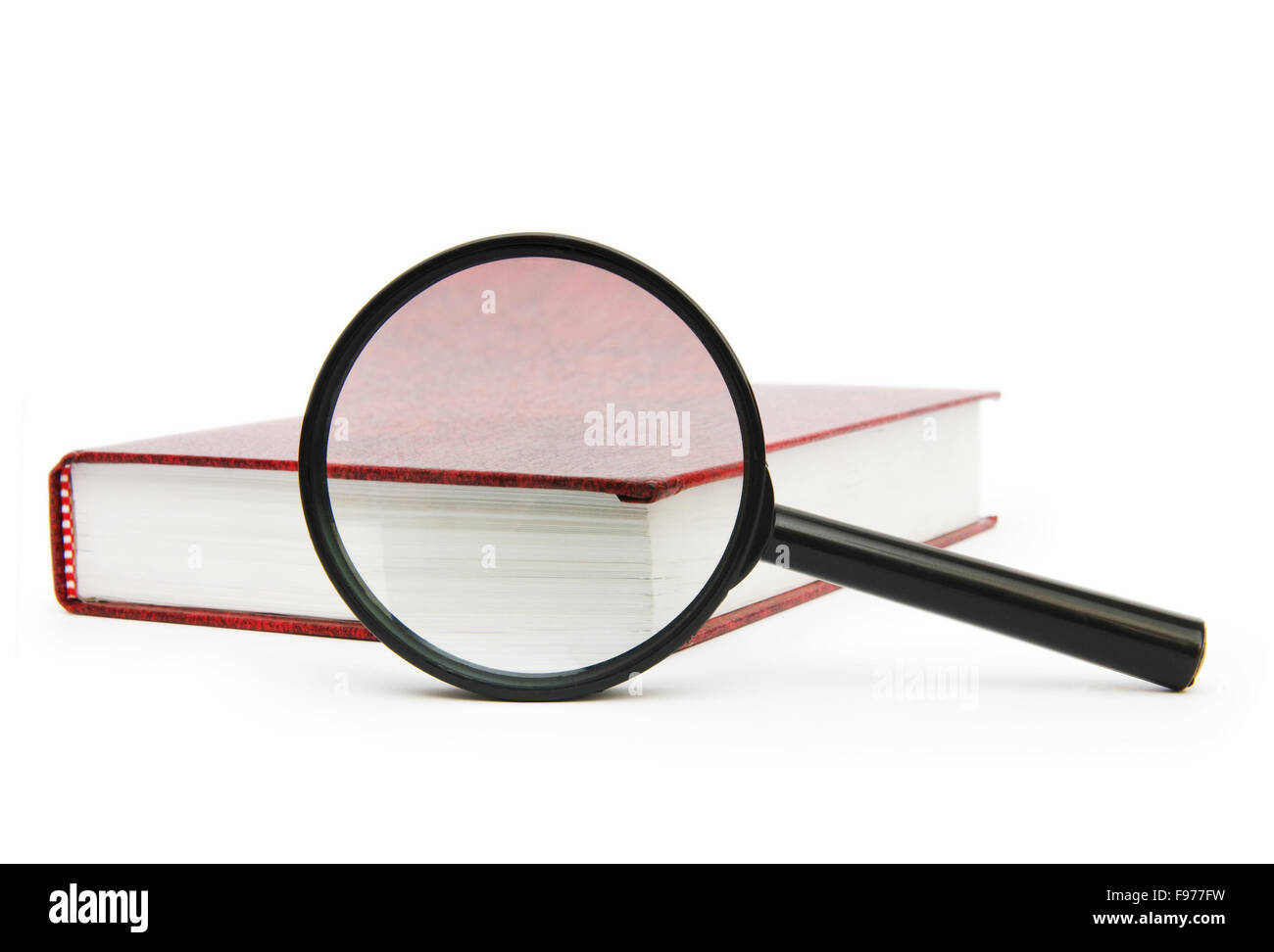 Magnifying glass over the stack of books Stock Photo - Alamy