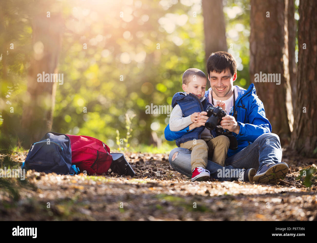 Father and son enjoying a walk in the forest Stock Photo - Alamy