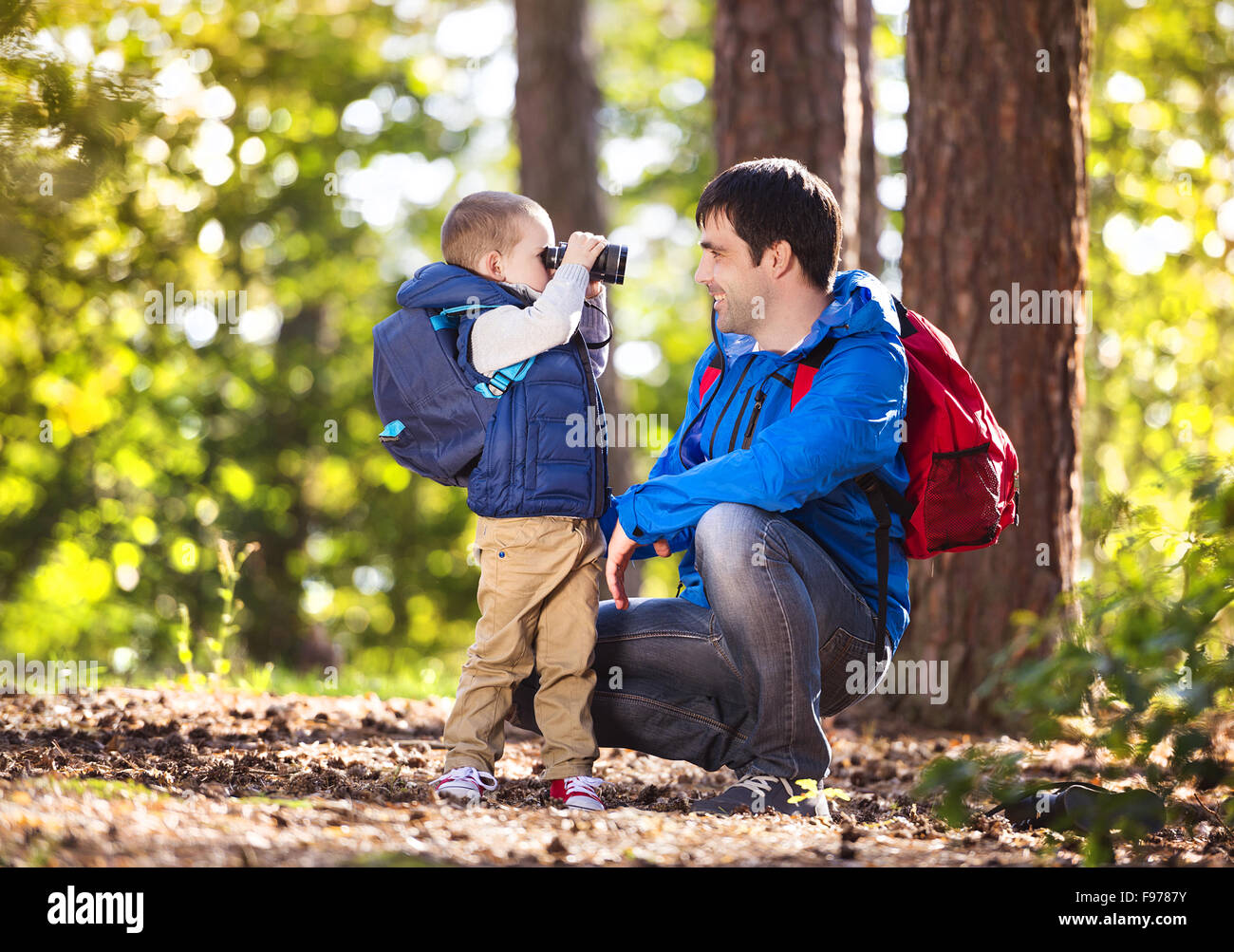 Father and son enjoying a walk in the forest Stock Photo - Alamy