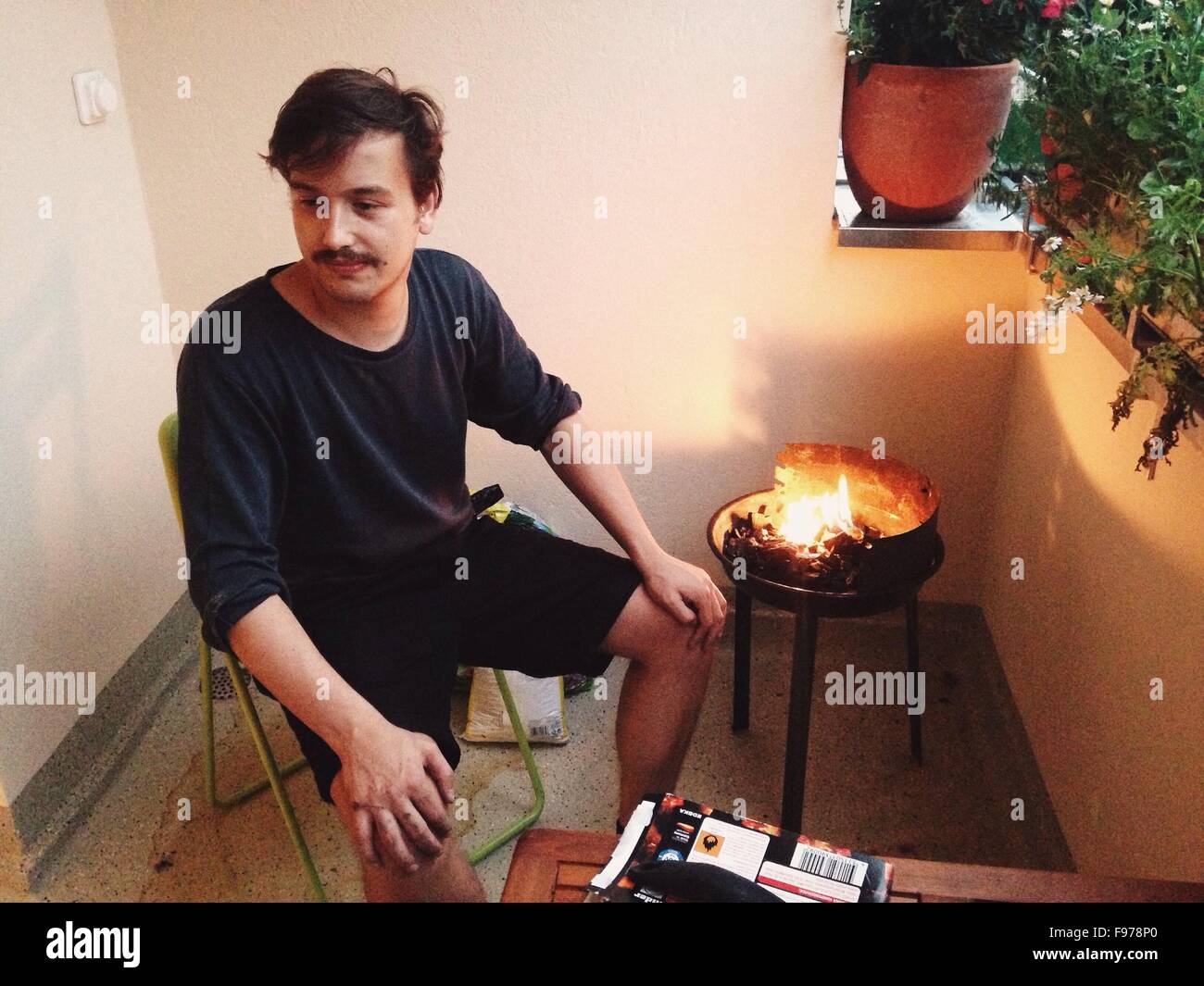 Man Sitting Near Fire High Resolution Stock Photography and Images - Alamy