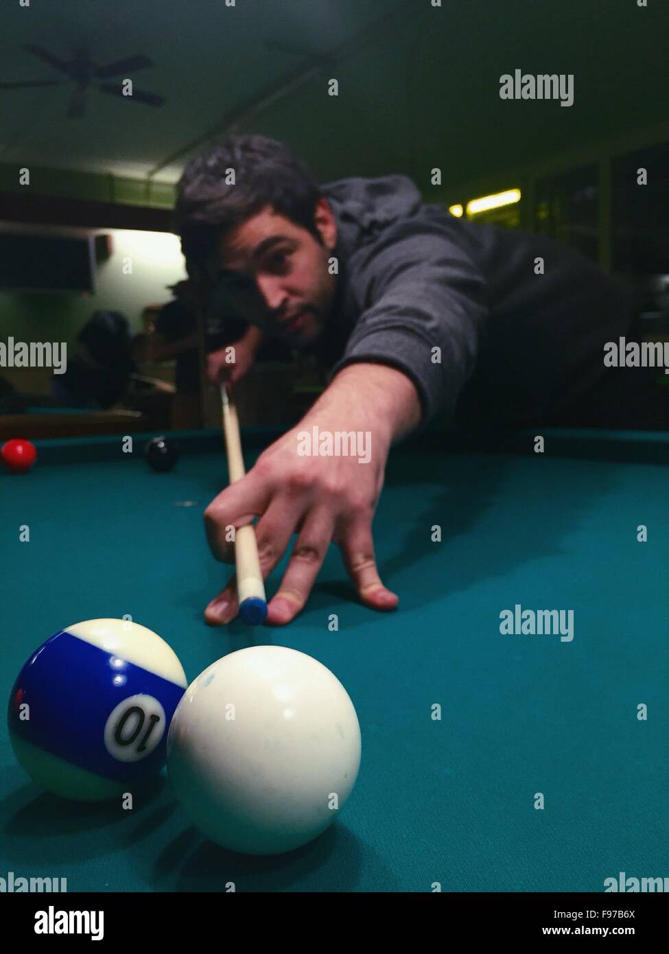 Young man playing pool hi-res stock photography and images - Alamy