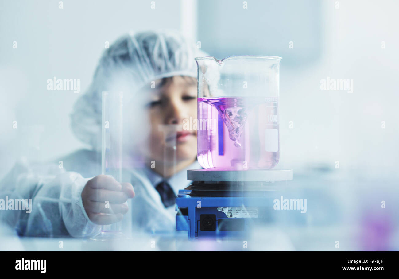 cute little male child have experiment with test tubes in bright modern ...