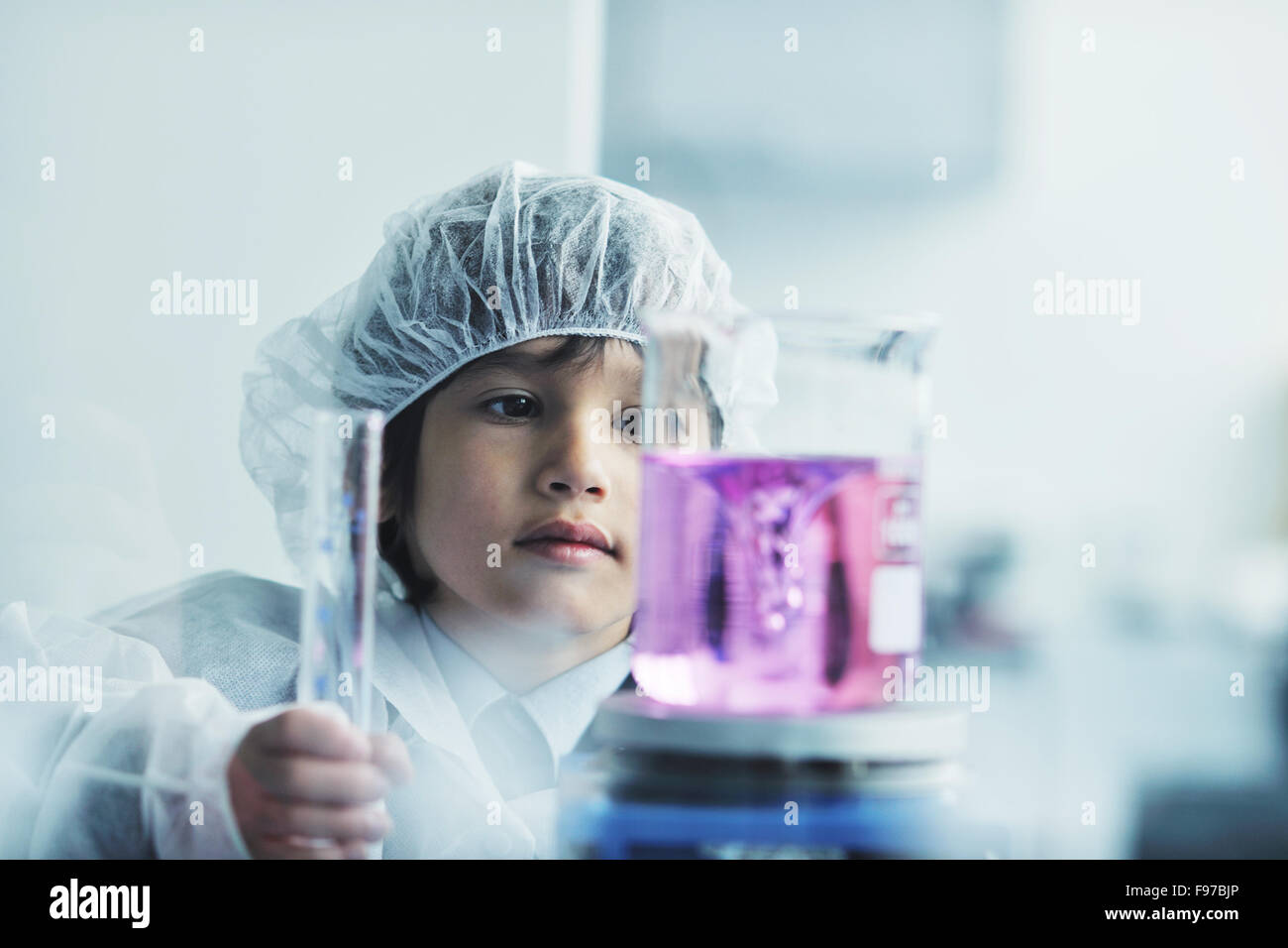 cute little male child have experiment with test tubes in bright modern ...