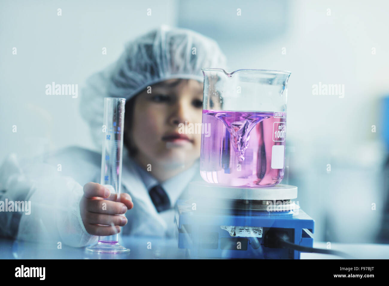 cute little male child have experiment with test tubes in bright modern ...