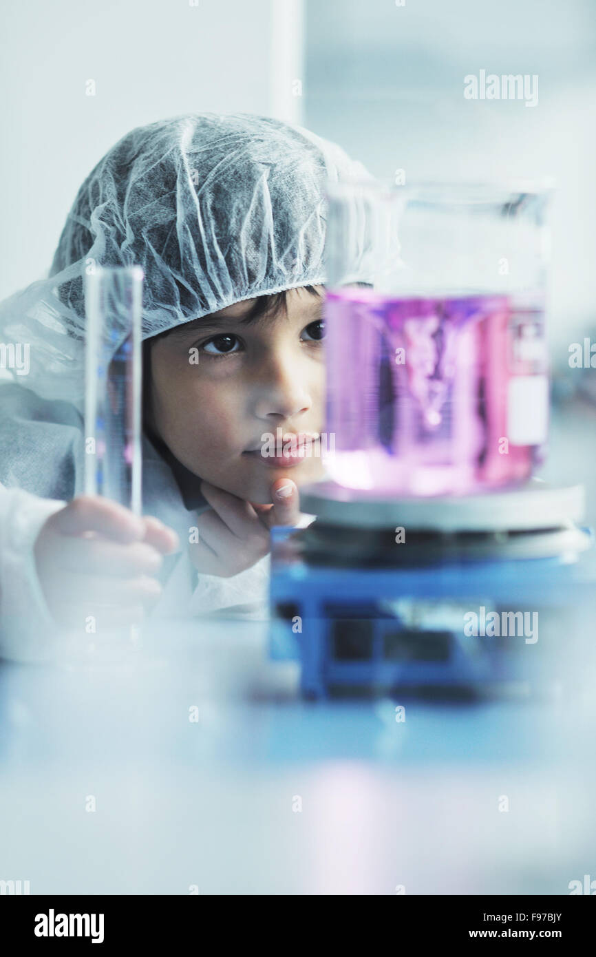 cute little male child have experiment with test tubes in bright modern ...