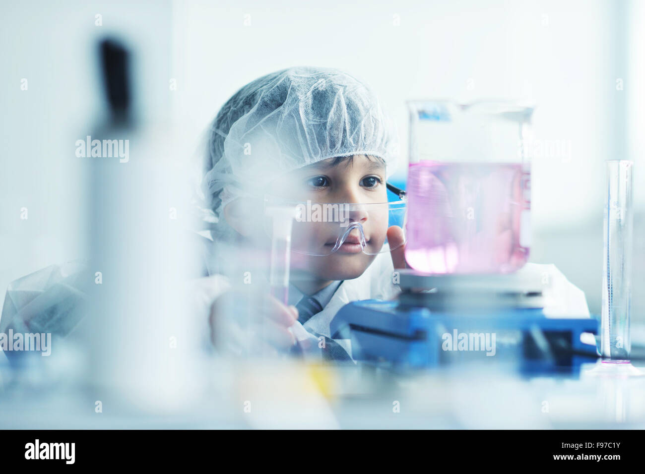 cute little male child have experiment with test tubes in bright modern ...