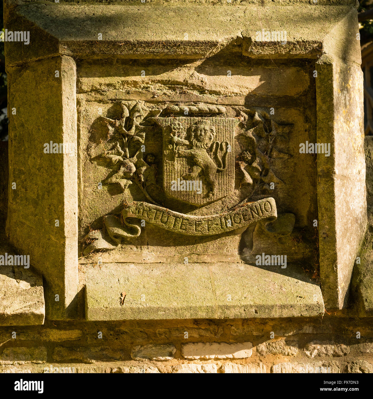 Stone panel with coat of arms with lion on shield and motto VIRTUTE ET ...