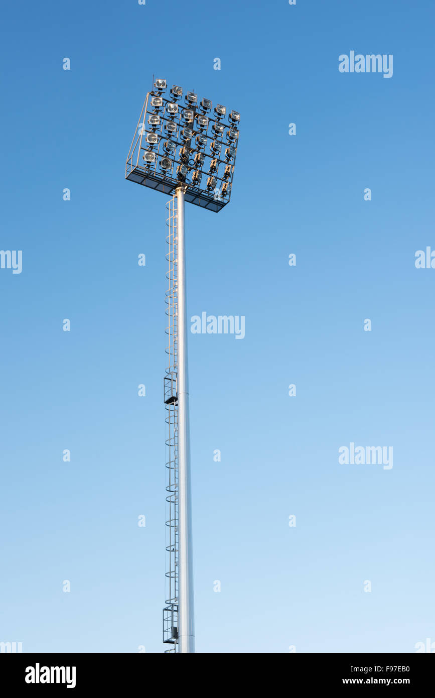 sportlights tower with blue sky background Stock Photo - Alamy
