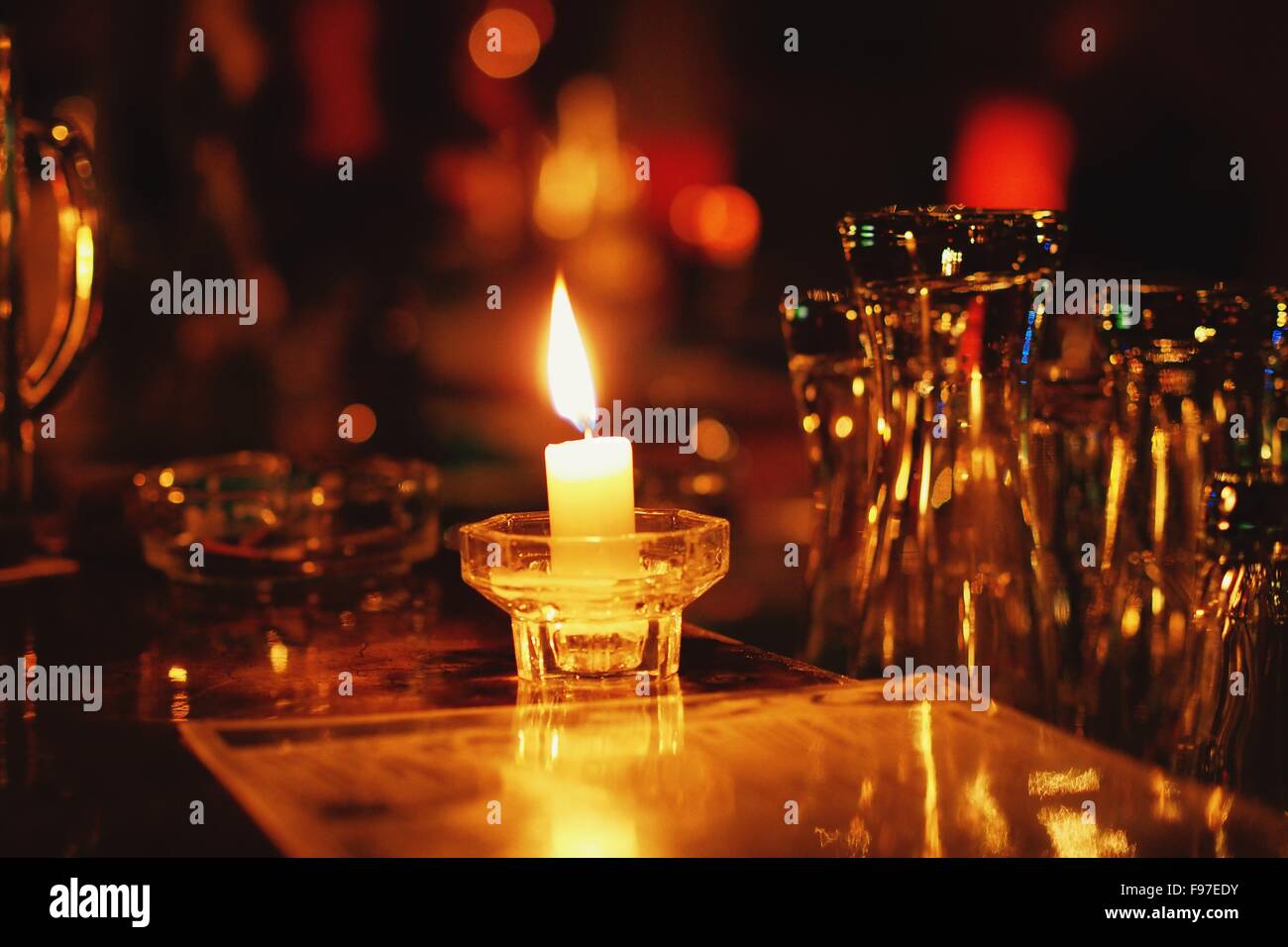 Lit Candle On Bar Counter Stock Photo - Alamy