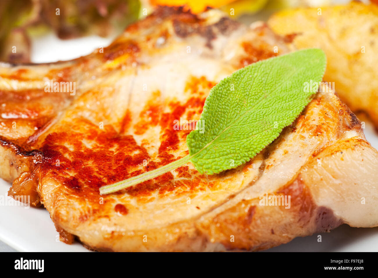 sage leaf on a grilled pork steak Stock Photo - Alamy