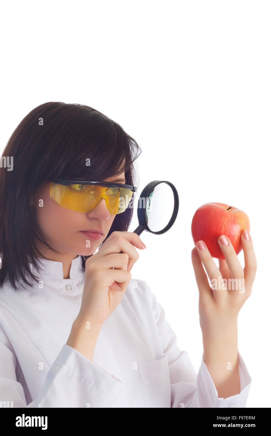Female scientist looking at apple through magnifying lens Stock Photo ...