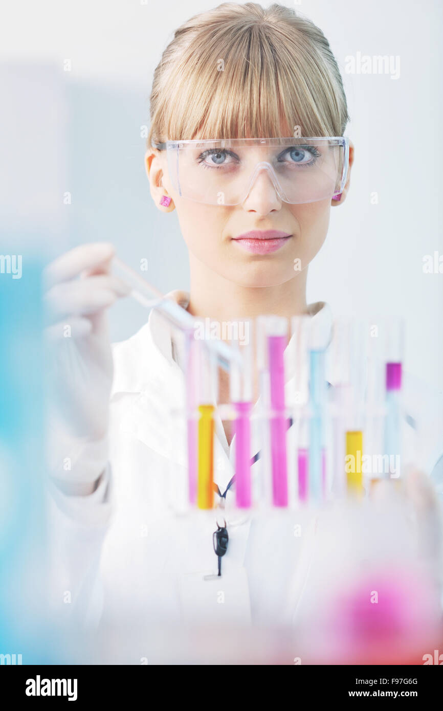 doctor student female researcher holding up a test tube in chemistry ...