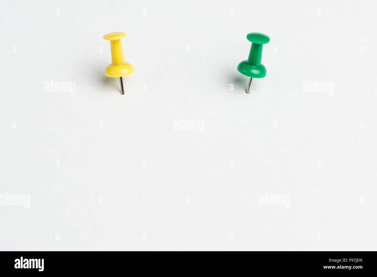 2 colored pins on a white background Stock Photo - Alamy