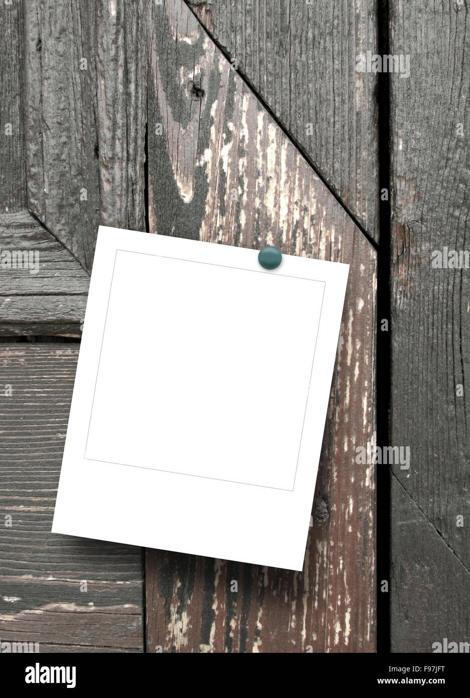 One blank square instant photo frame with blue pin on brown wooden door ...