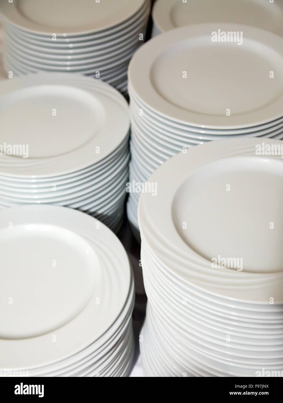 Many white different plates stacked together Stock Photo - Alamy