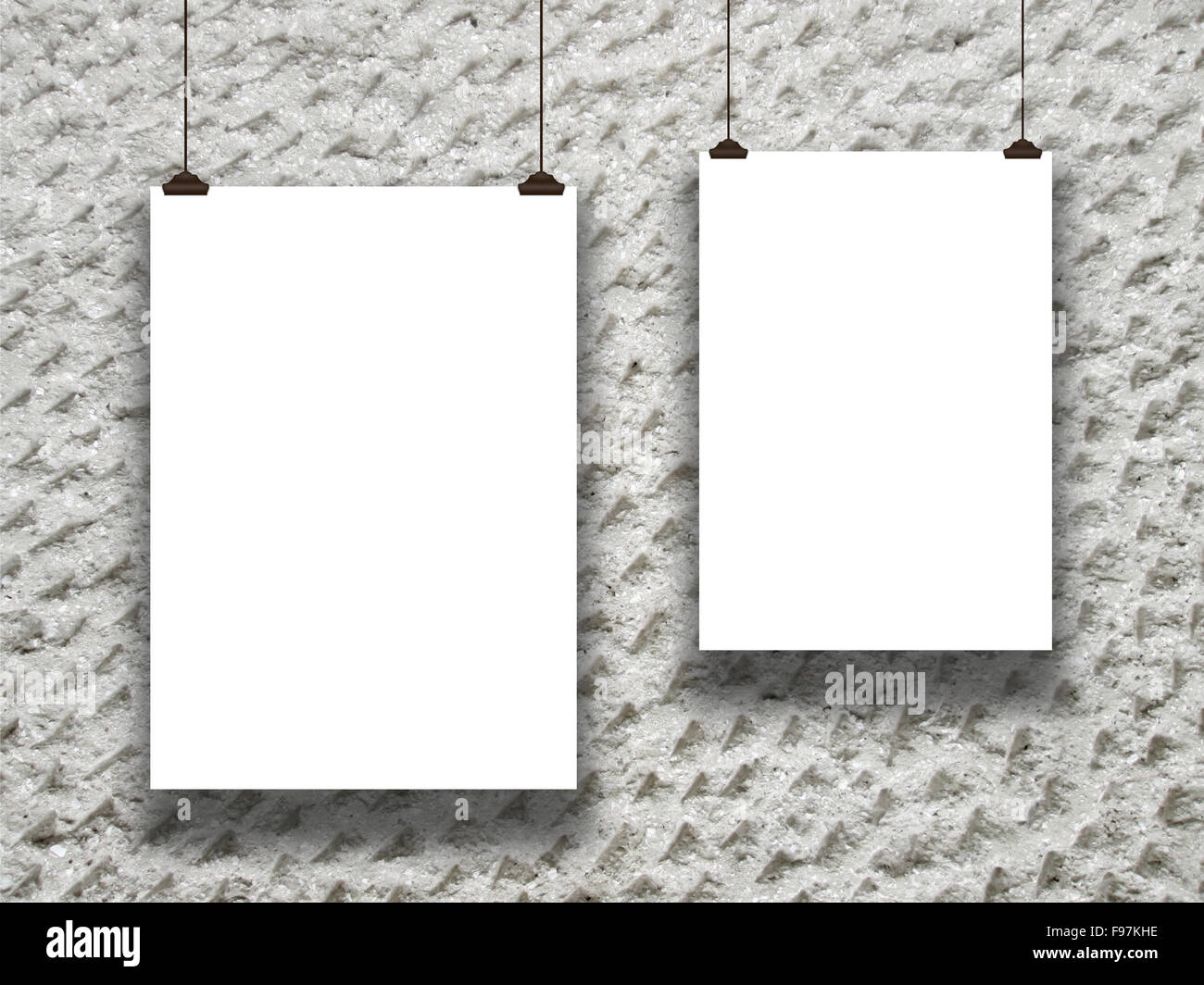 Two asymmetrical paper sheet frames on gray concrete wall background ...