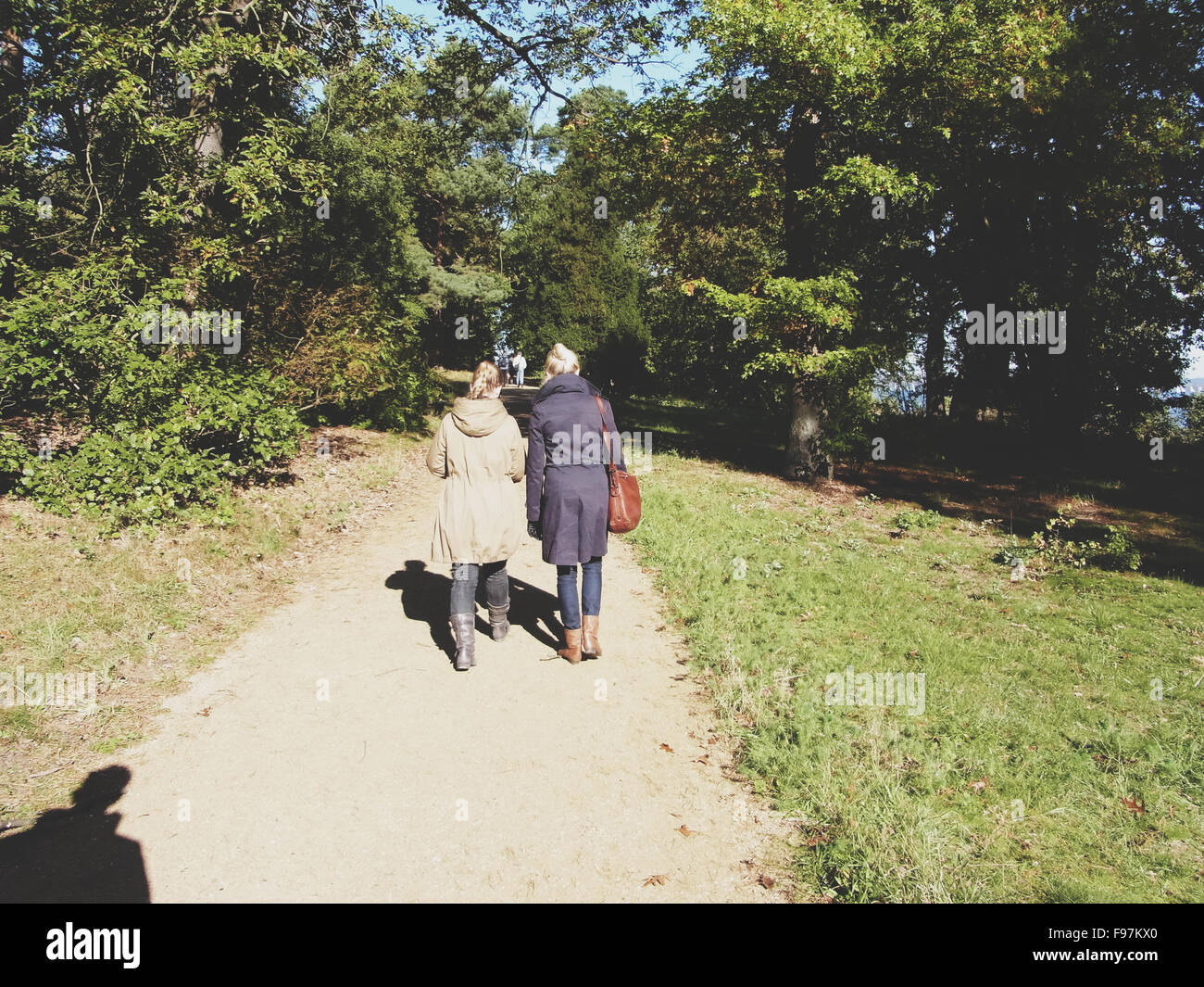 Three People Walking Along Footpath Stock Photo - Alamy