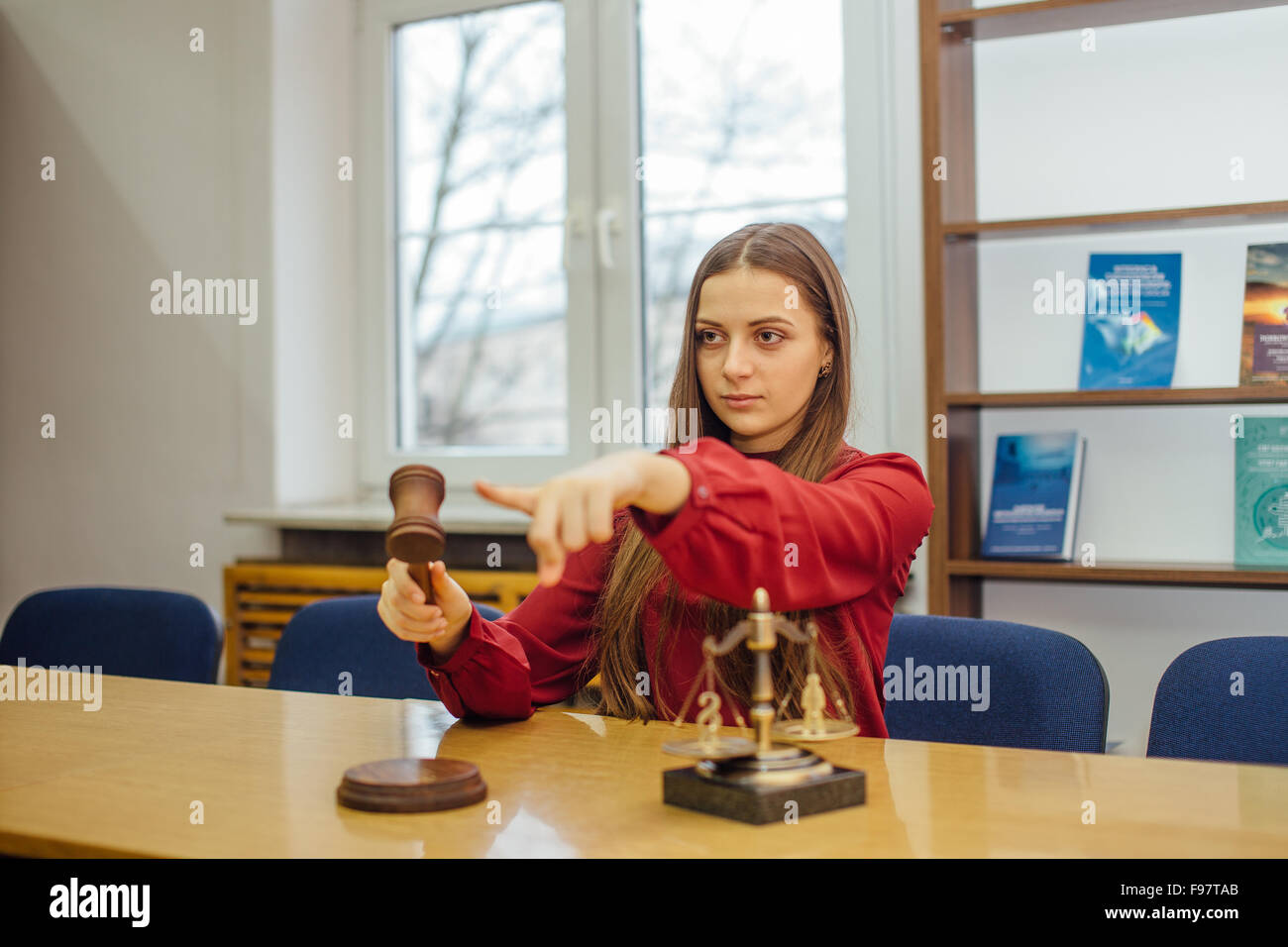 Judge in a courtroom striking the gavel and smile Stock Photo - Alamy