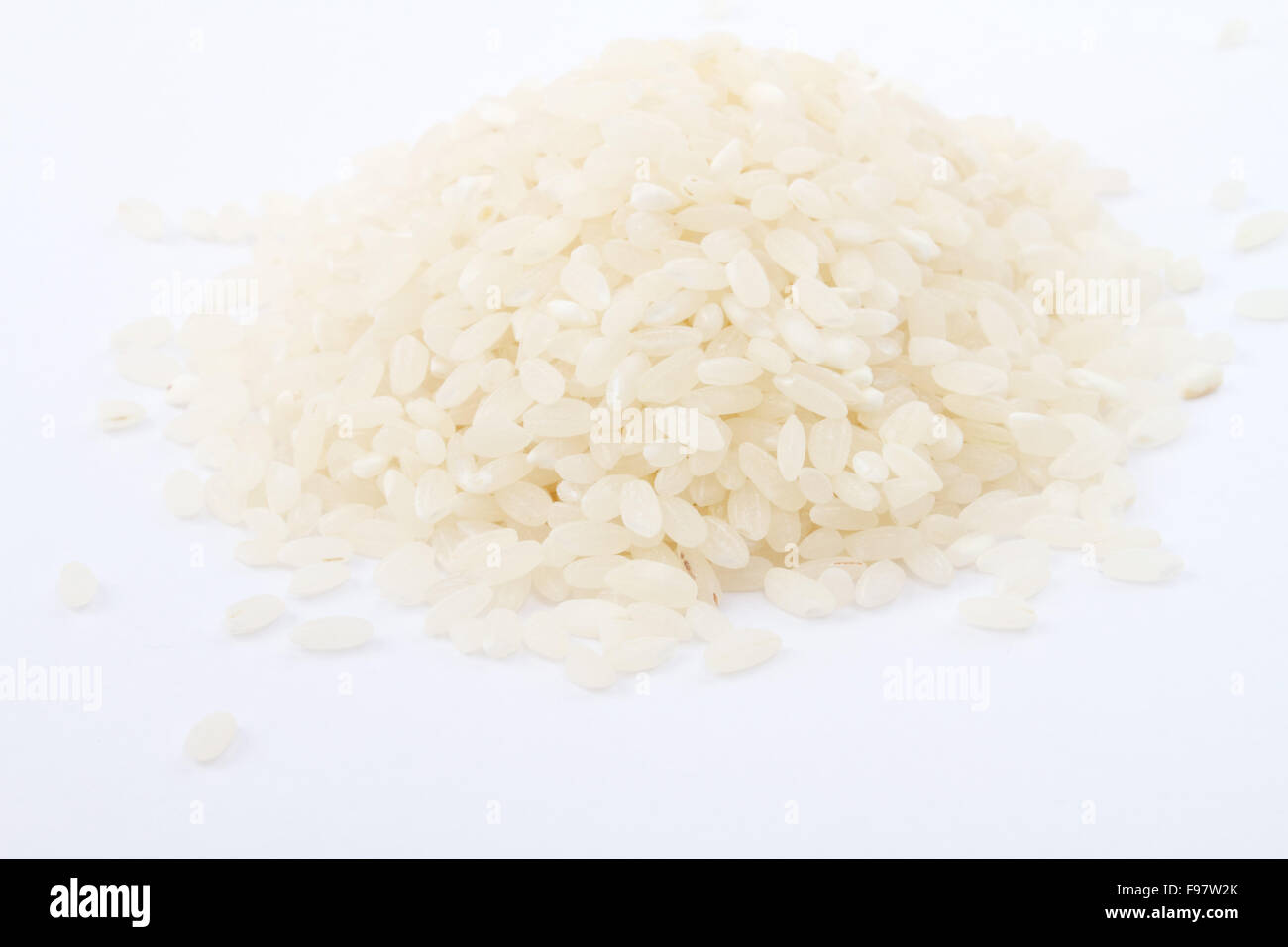 Pile of organic rice (on white Stock Photo - Alamy