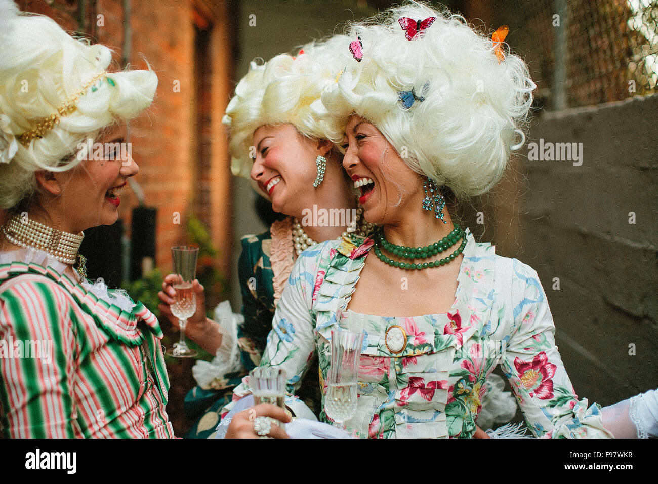 Women laughing during Victorian themed dinner Stock Photo - Alamy