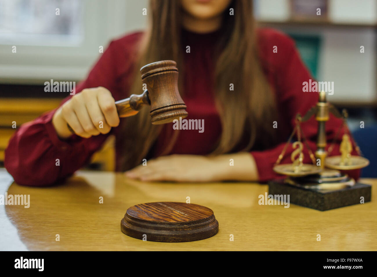 Judge in a courtroom striking the gavel and smile Stock Photo - Alamy