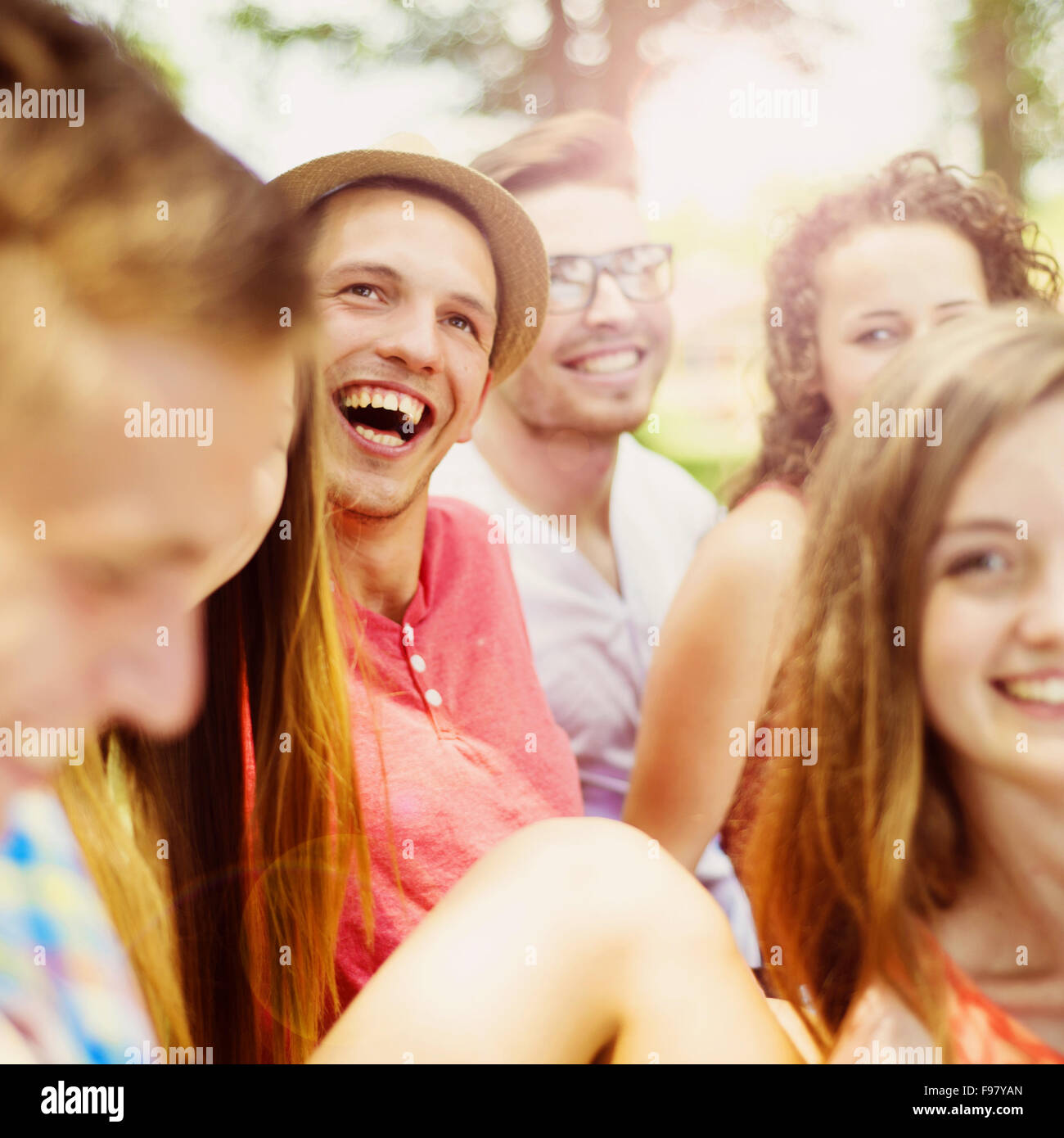 Group of young people having fun in park, sitting on the grass Stock ...