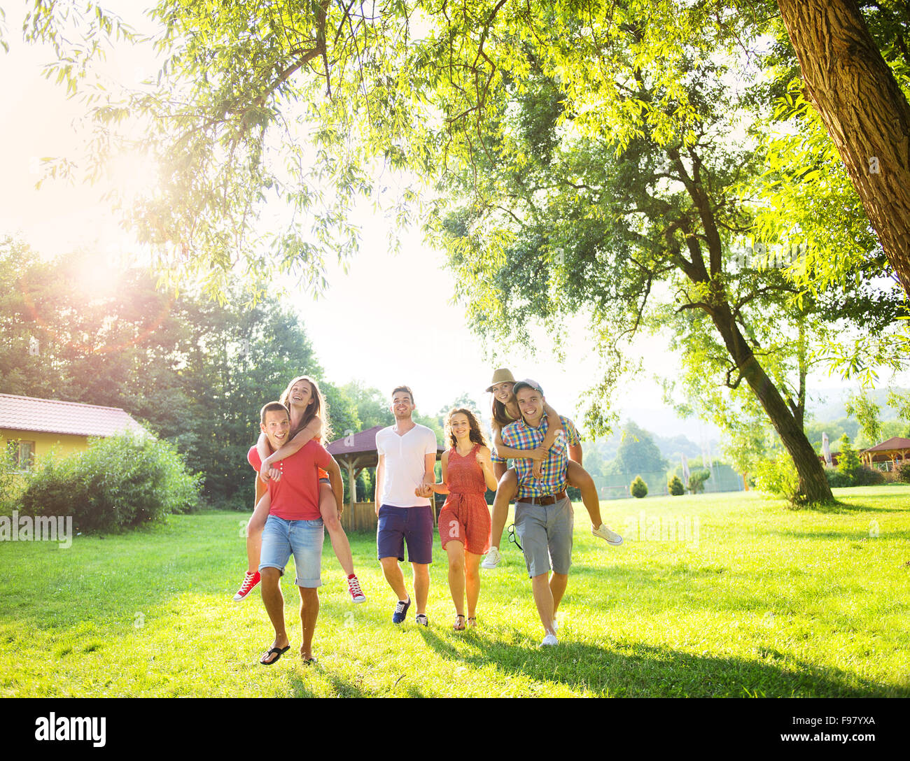Group of five teenage friends having fun in park Stock Photo - Alamy