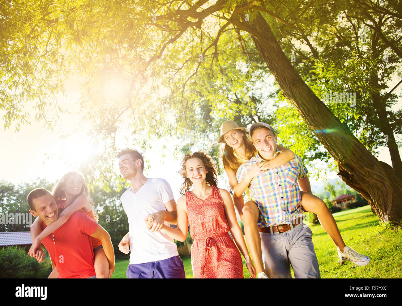 Group of five teenage friends having fun in park Stock Photo - Alamy