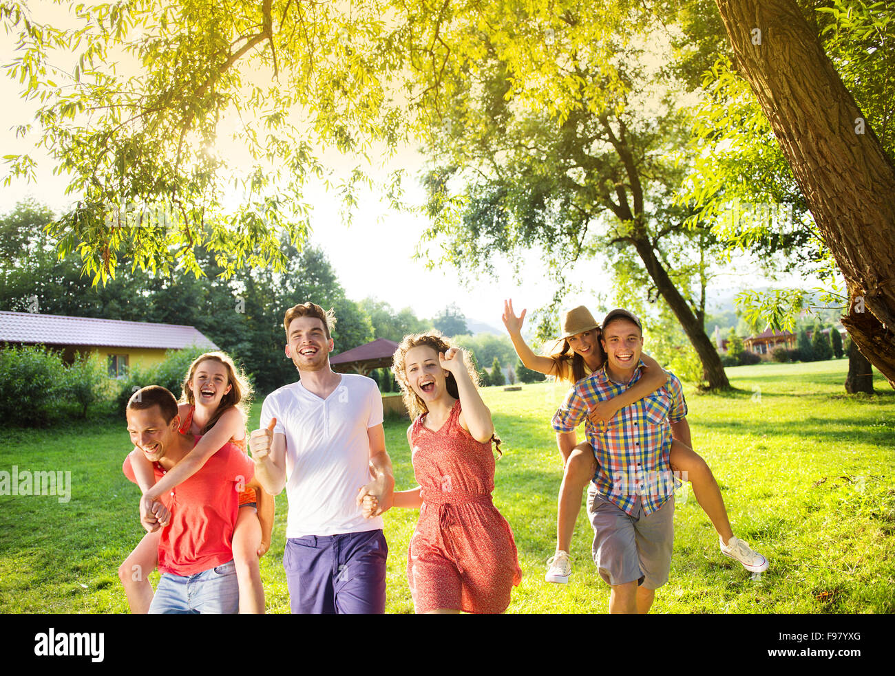 Group of five teenage friends having fun in park Stock Photo - Alamy