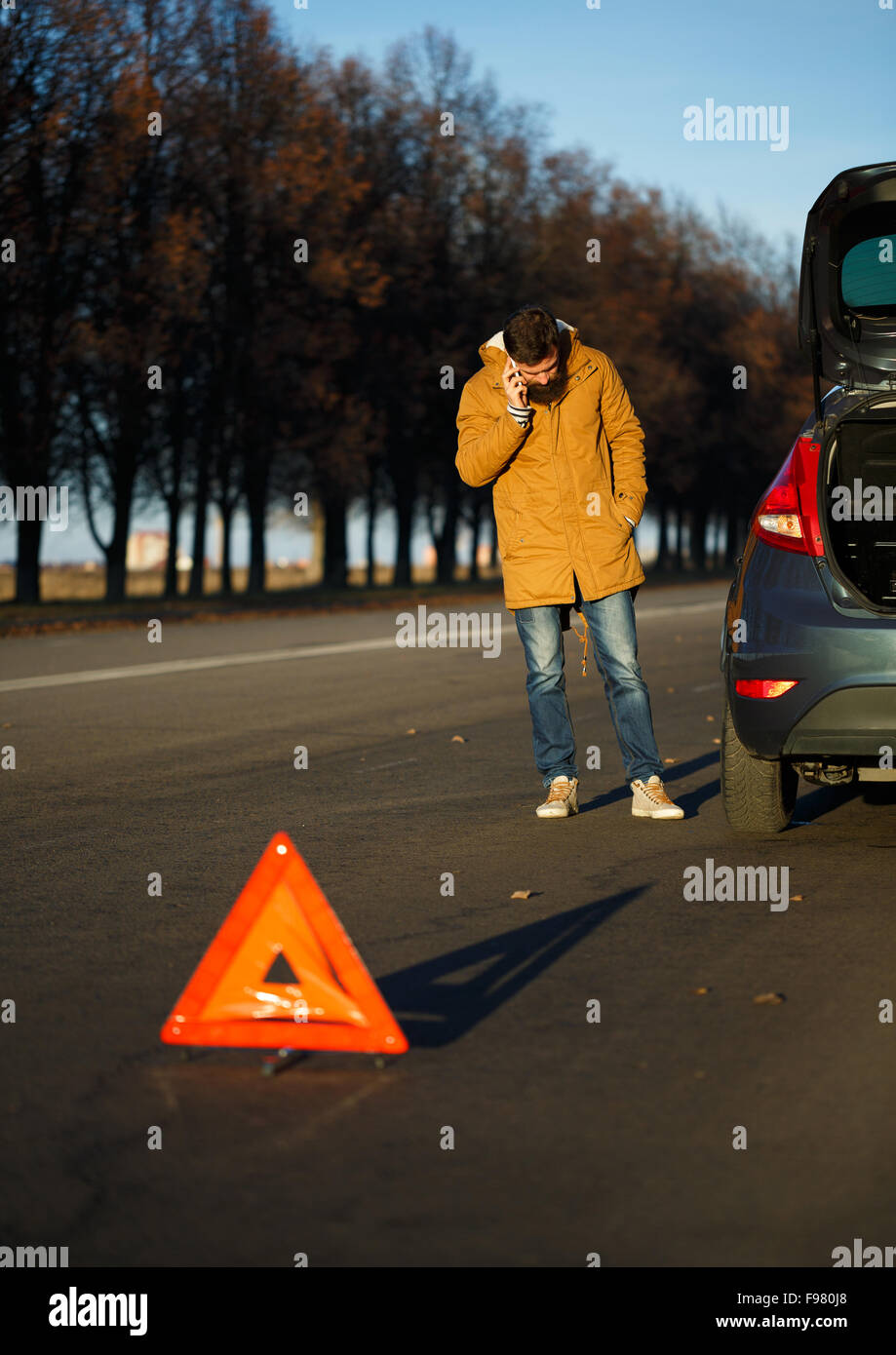 Driver man examining damaged automobile cars after breaking Stock Photo ...