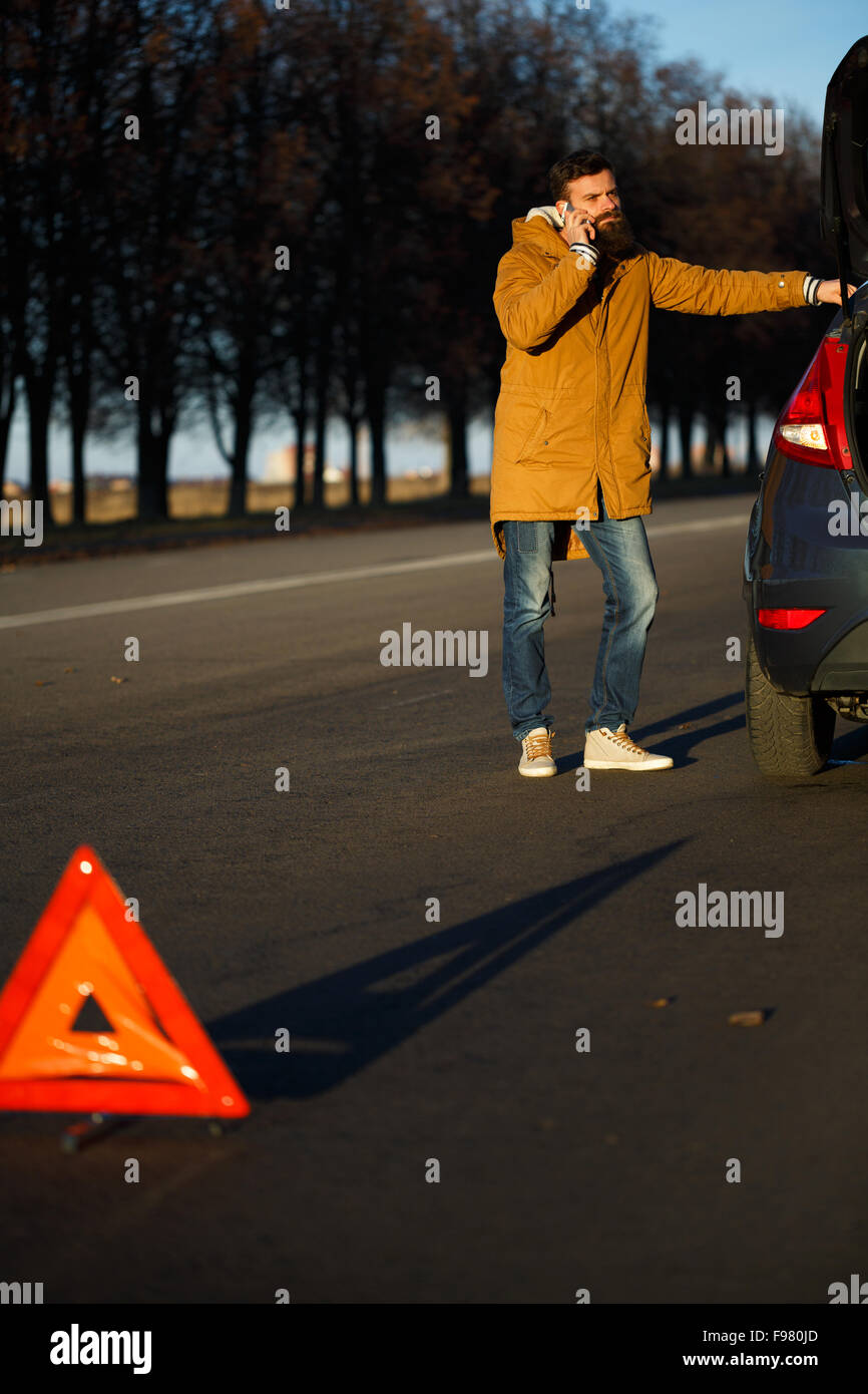 Driver man examining damaged automobile cars after breaking Stock Photo ...