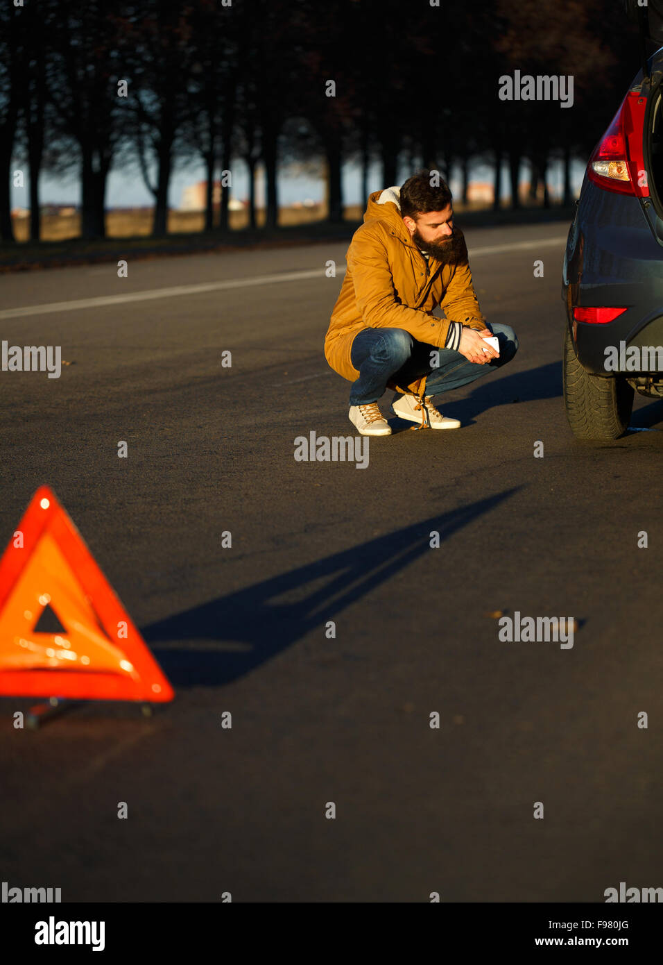 Driver man examining damaged automobile cars after breaking Stock Photo ...