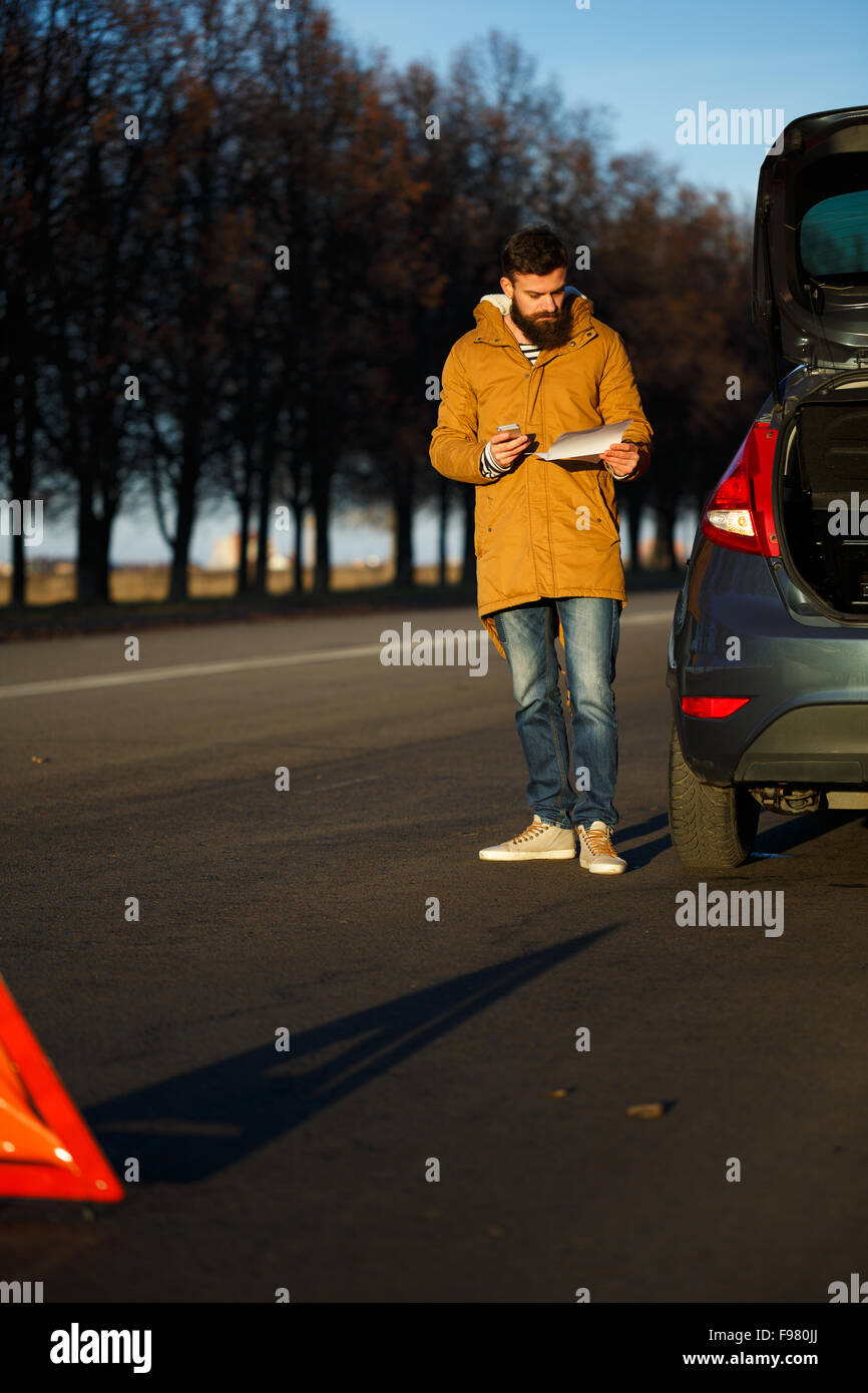 Driver man examining damaged automobile cars after breaking Stock Photo ...
