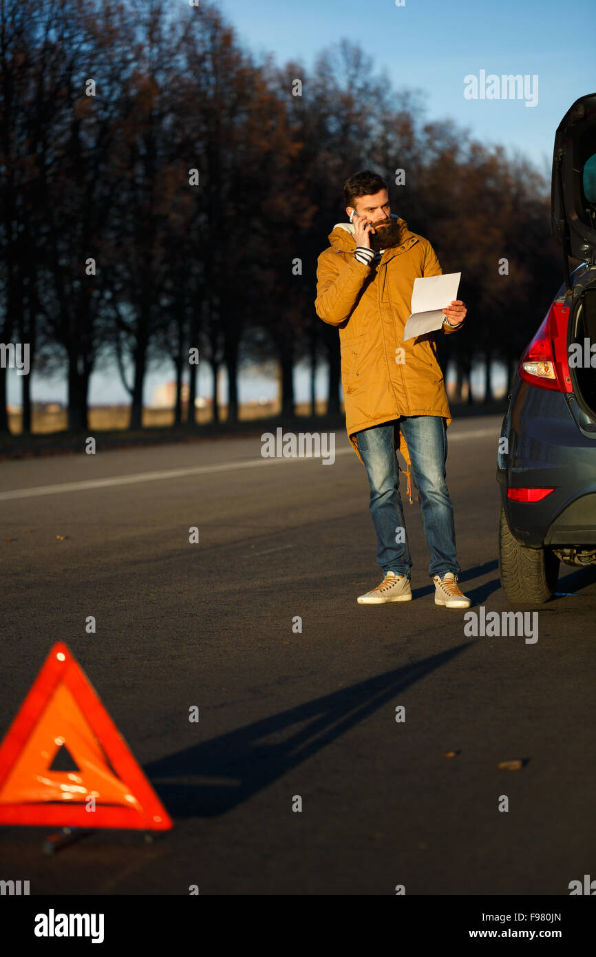 Driver man examining damaged automobile cars after breaking Stock Photo ...