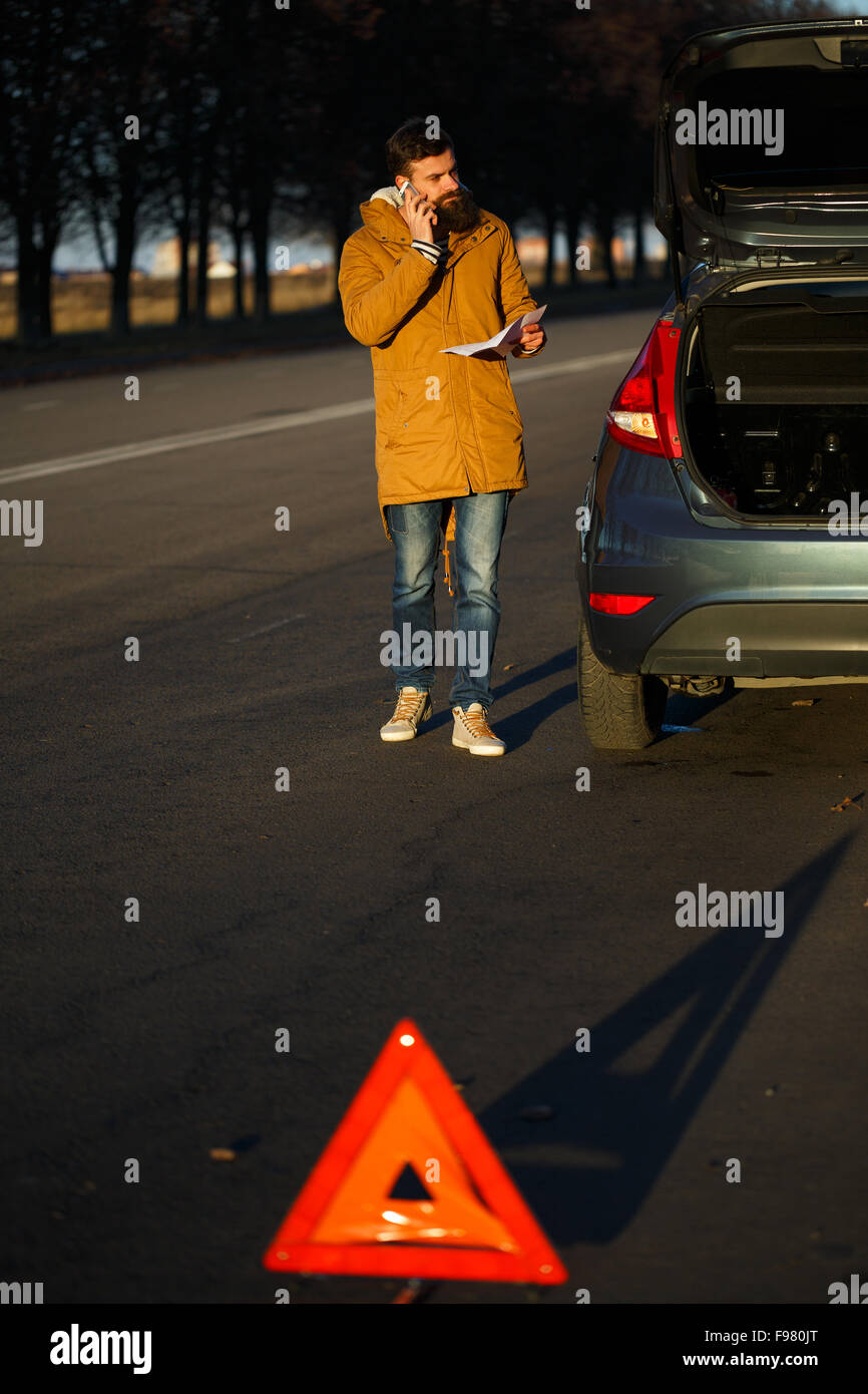 Driver man examining damaged automobile cars after breaking Stock Photo ...