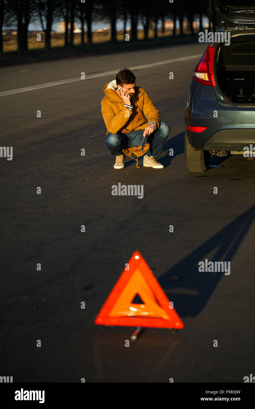 Driver man examining damaged automobile cars after breaking Stock Photo ...