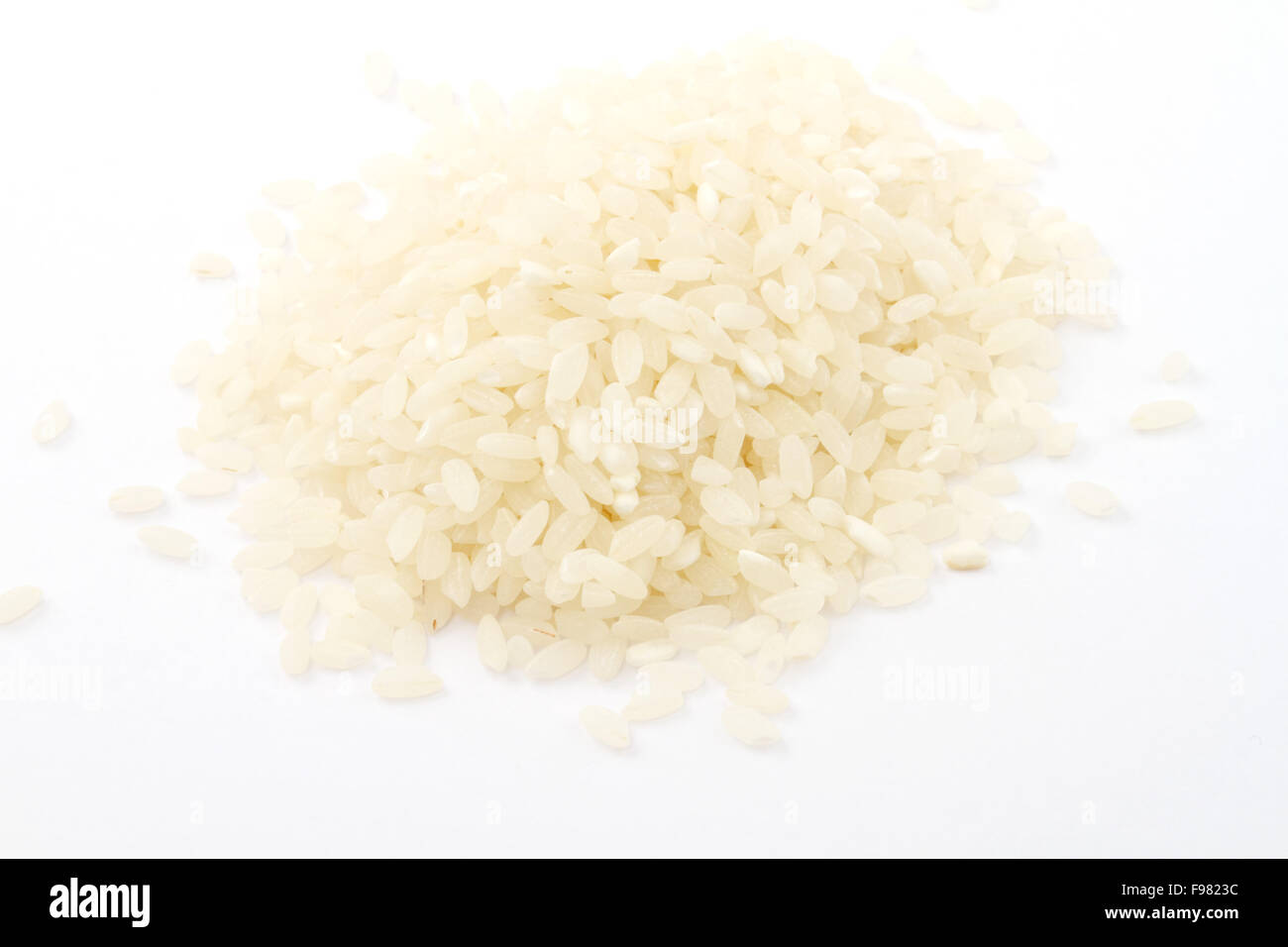 Pile of organic rice (on white Stock Photo - Alamy