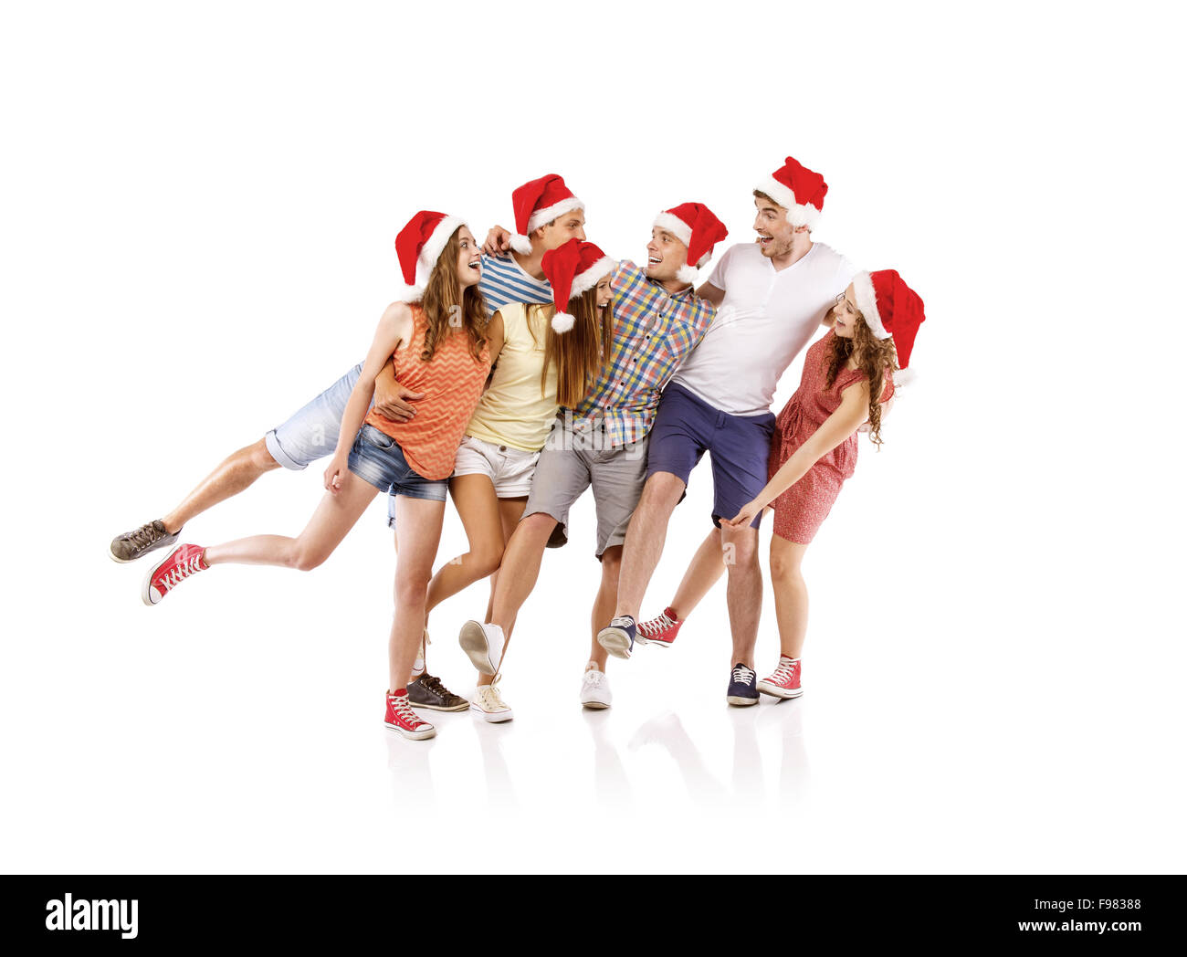 Group of young people in santa hats having fun, isolated on white ...