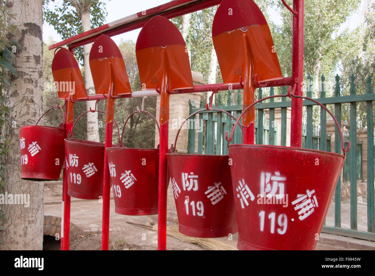 Red firebuckets and shovels with chinese characters Stock Photo - Alamy