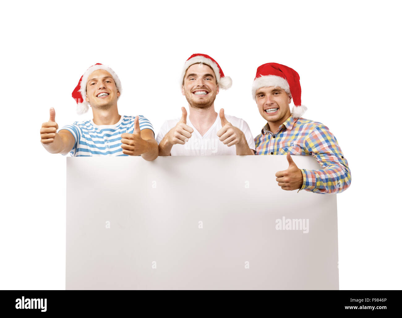 Three young men in santa hats with copy space, isolated on white ...