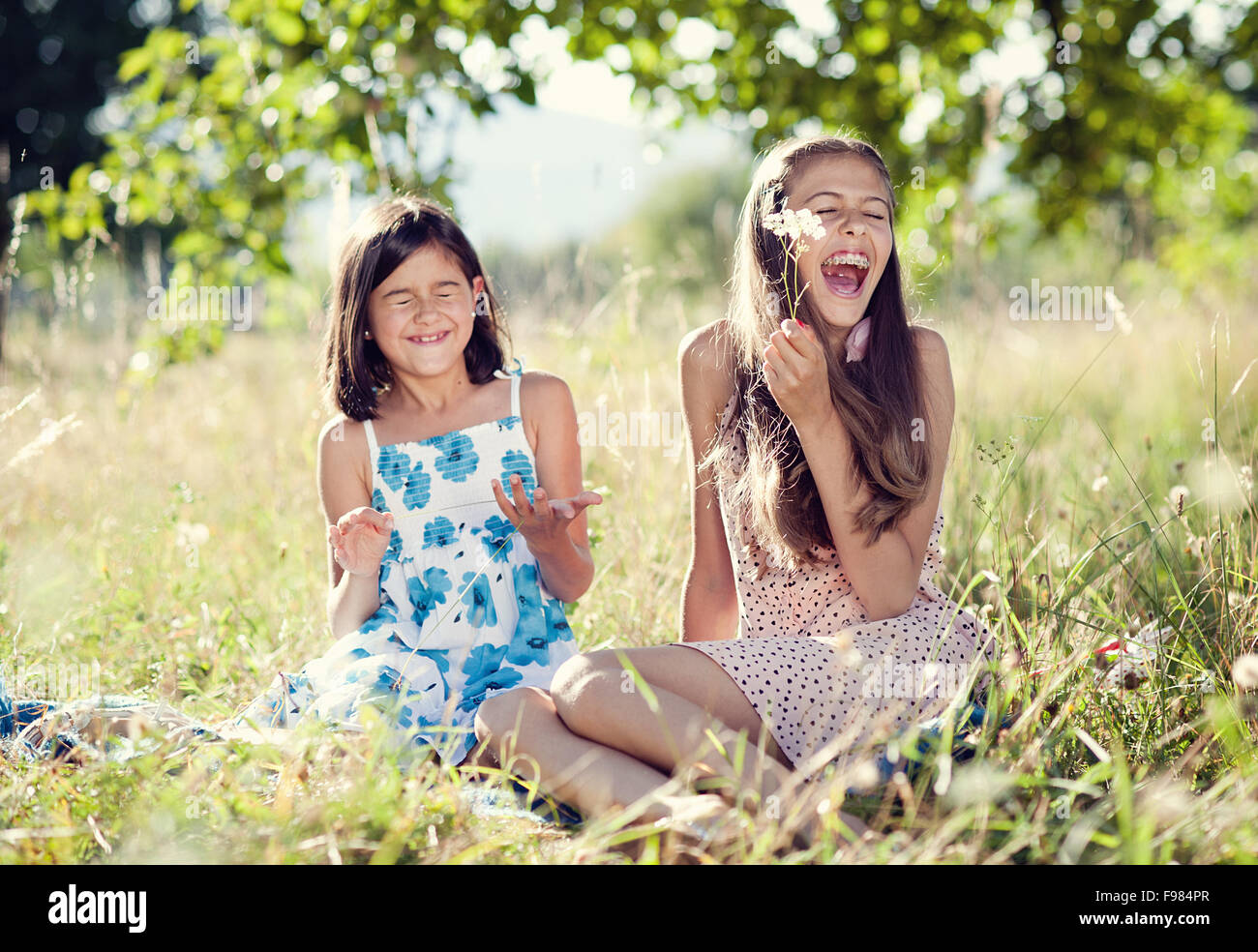 Two girls lying down laughing hi-res stock photography and images - Alamy