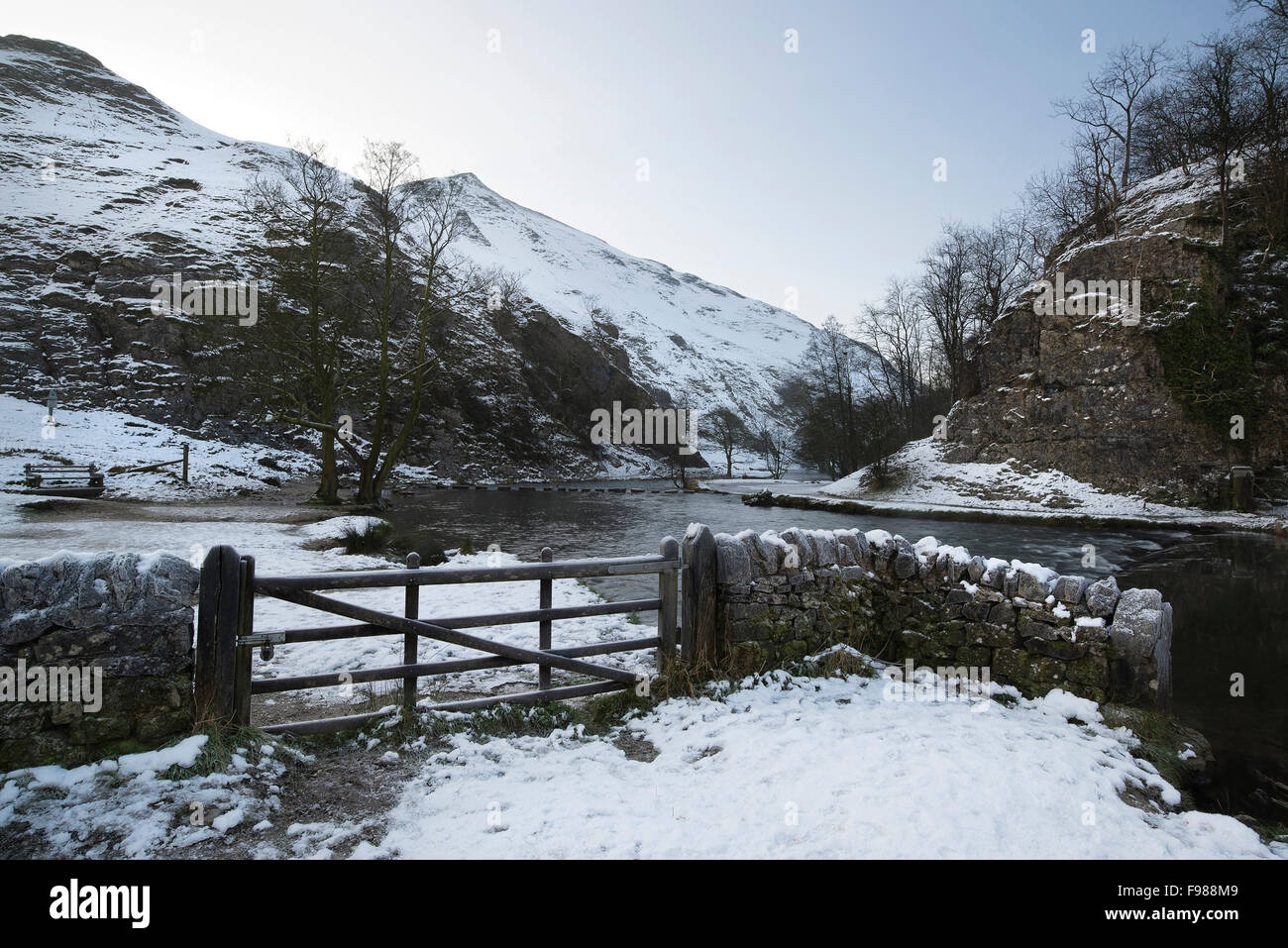 River flowing through snow covered Winter landscape in valley Stock ...
