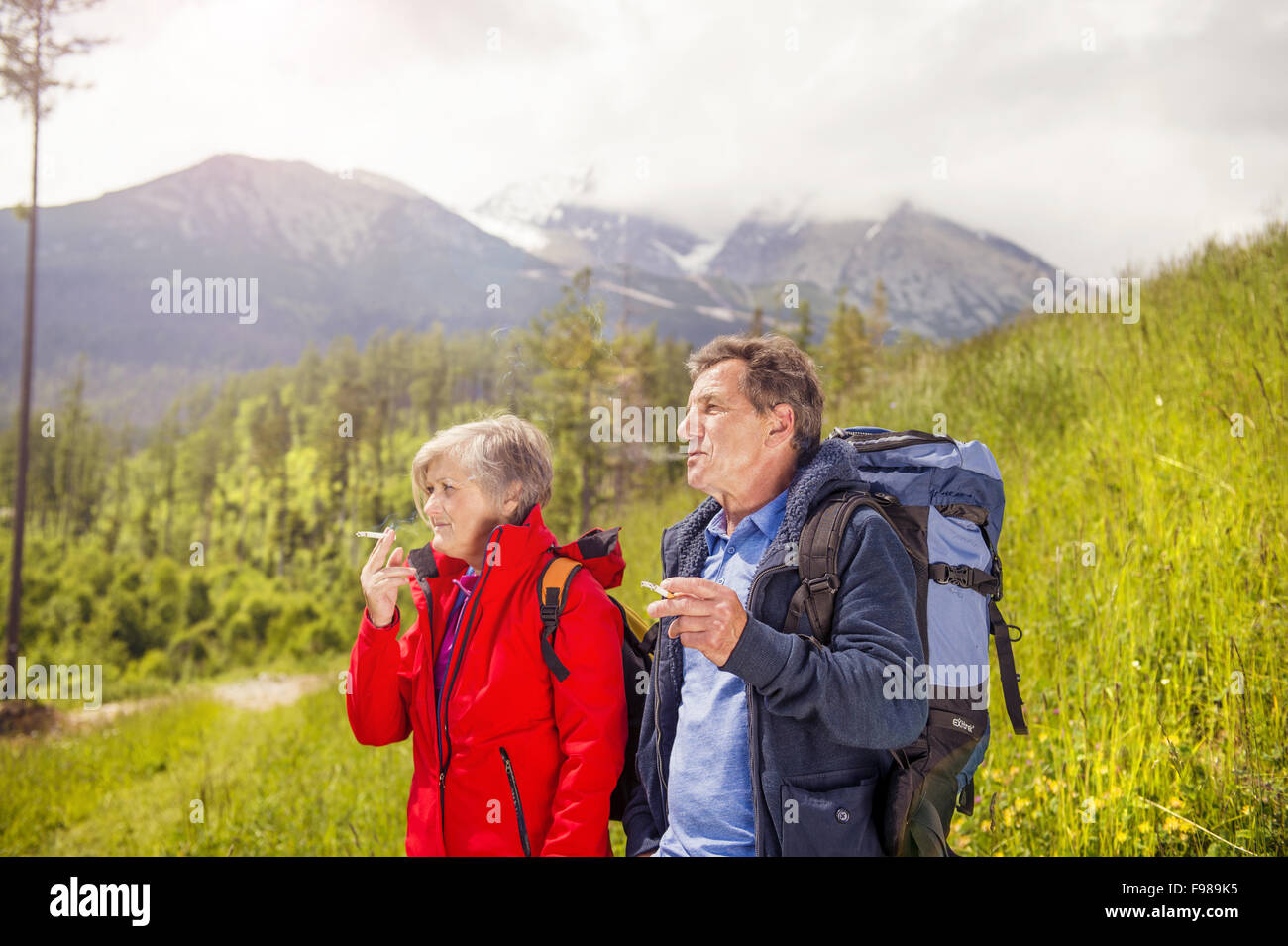 Senior hikers couple smoking during the walk in the mountains Stock ...