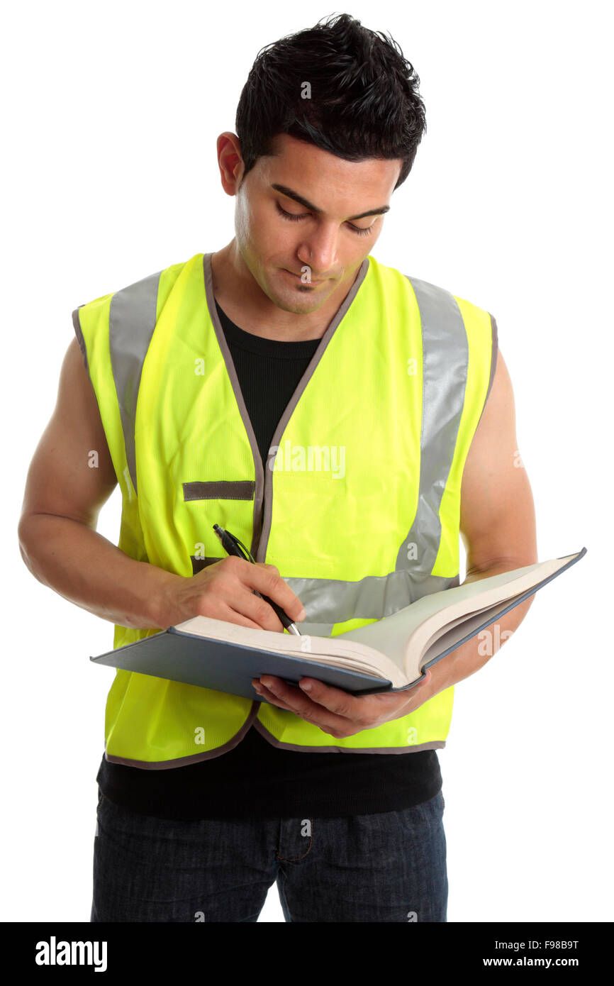 Builder writing in a book Stock Photo - Alamy