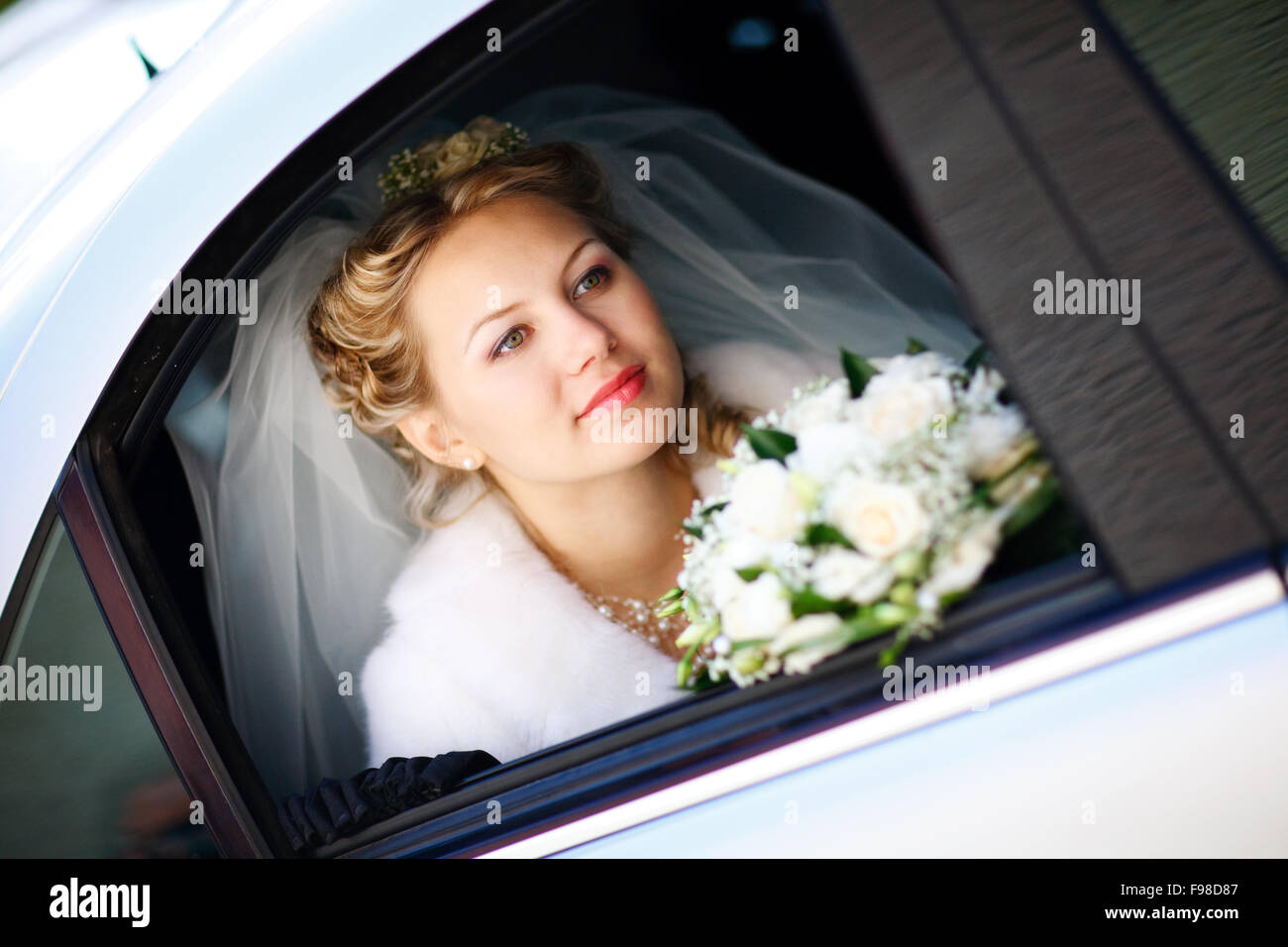 portrait of the bride in the wedding car Stock Photo - Alamy