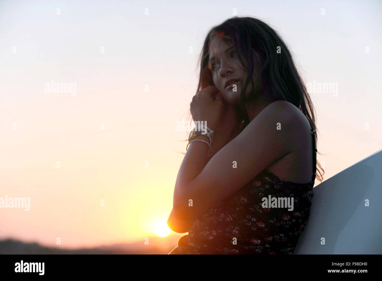 A young woman enjoys a Spanish sunset Stock Photo - Alamy