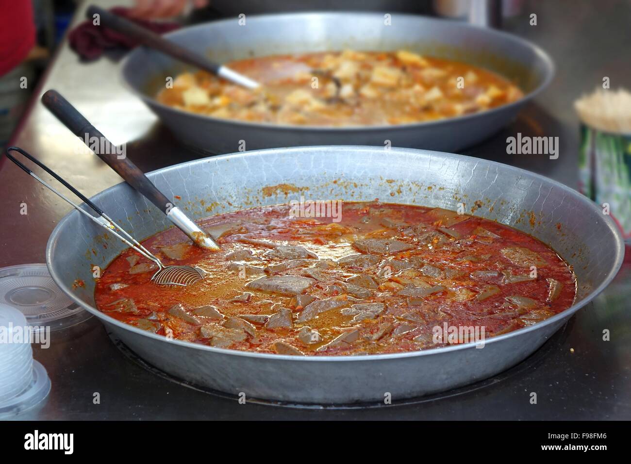 An outdoor vendor sells spicy soup with duck blood pudding Stock Photo ...