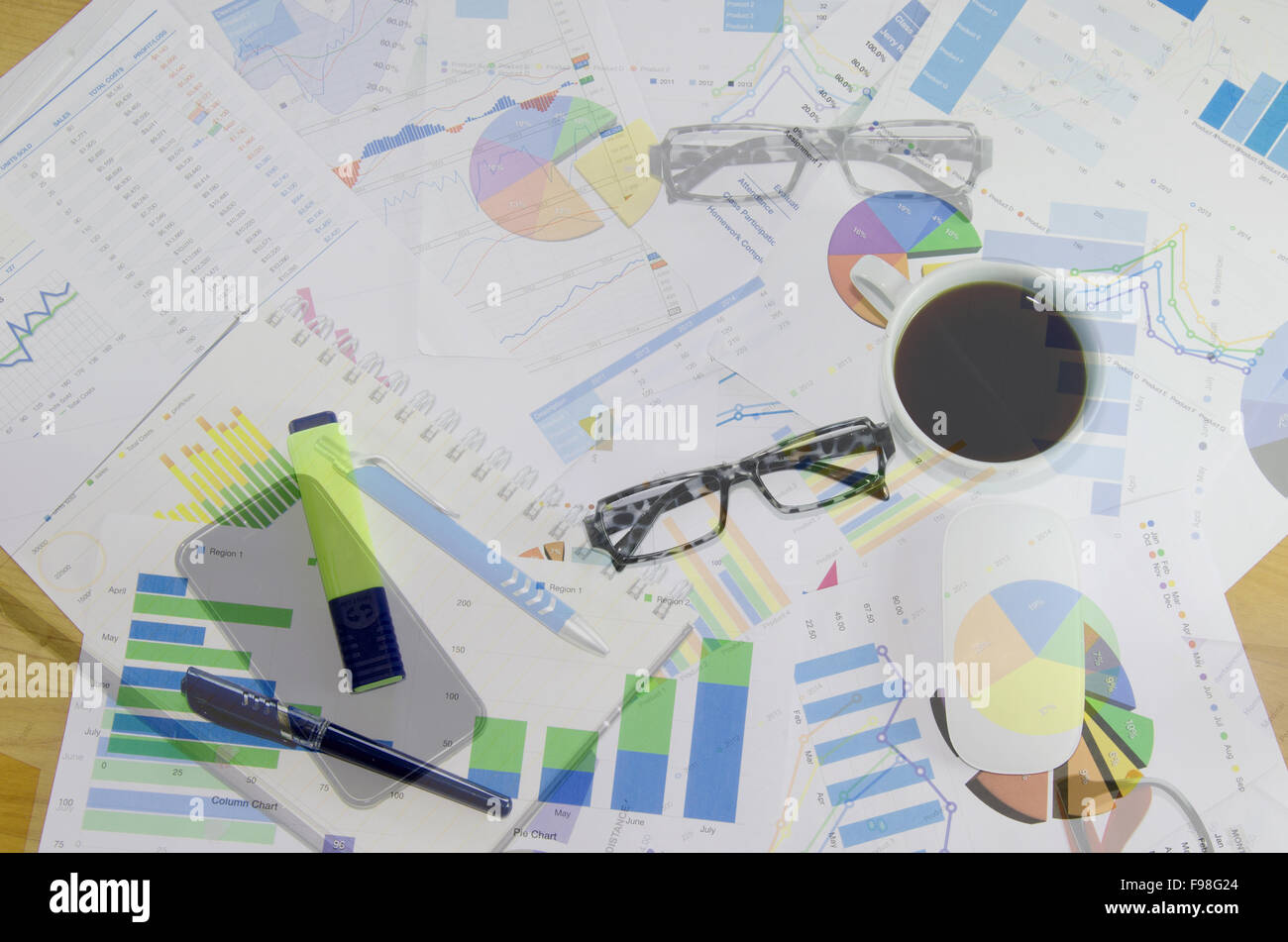 business documents over papers with numbers and charts. View from above ...