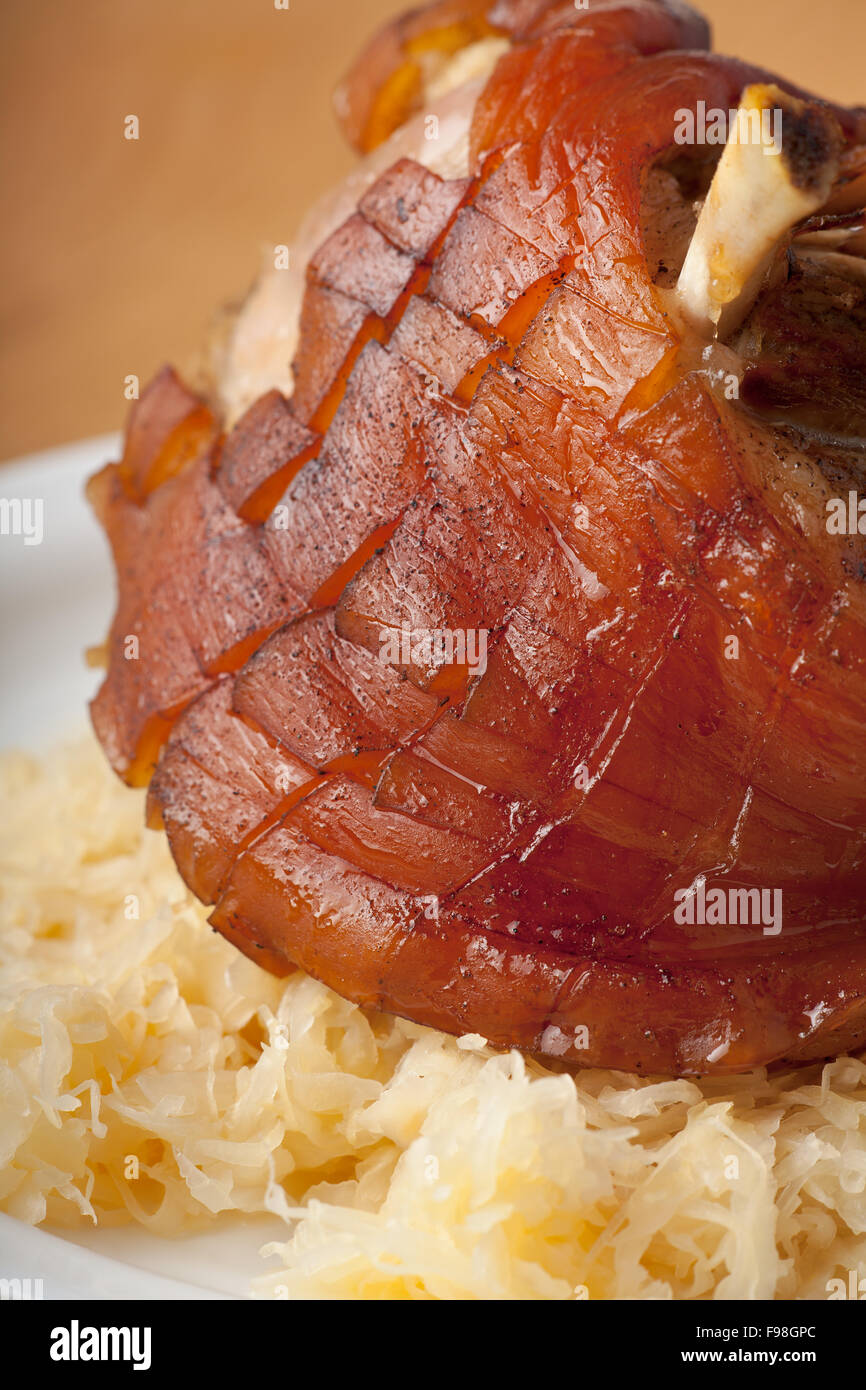grilled knuckle of pork on a wooden table Stock Photo - Alamy