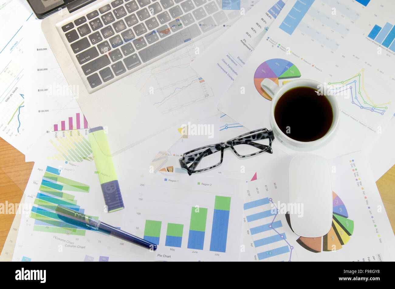 business documents over papers with numbers and charts. View from above ...